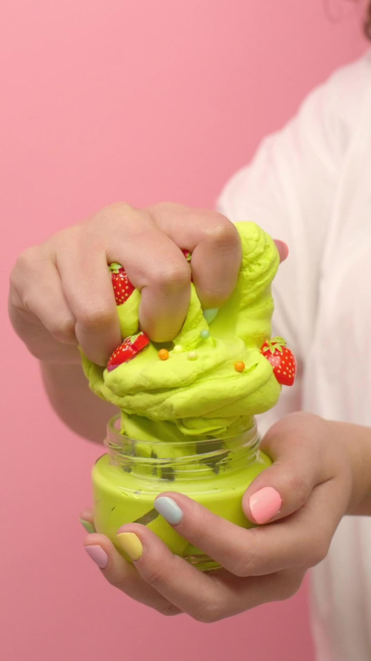 Woman squeezing green plasticine into ice cream - One News Page VIDEO