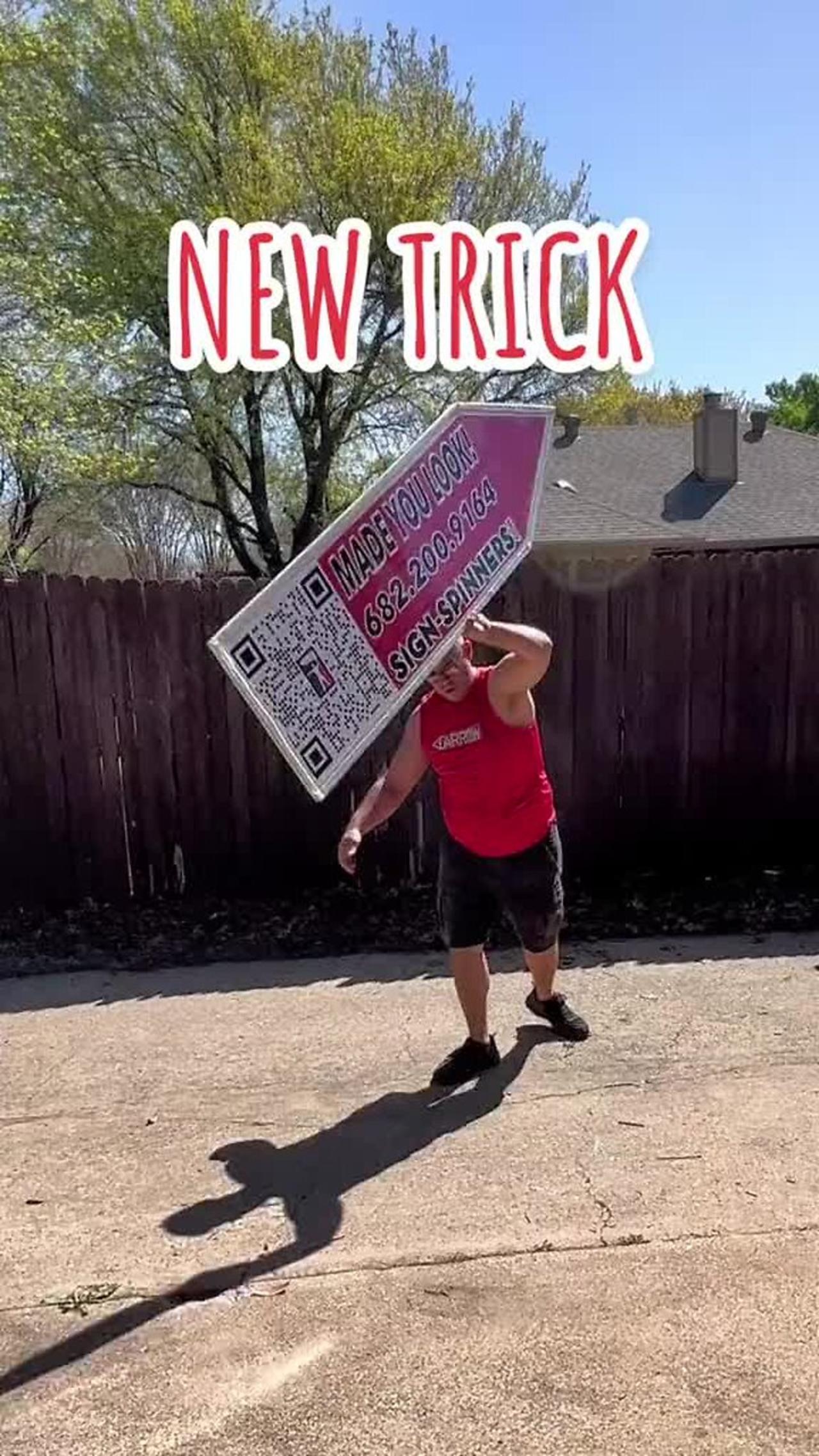 Sign spinner is showing off a new sign spinning - One News Page VIDEO
