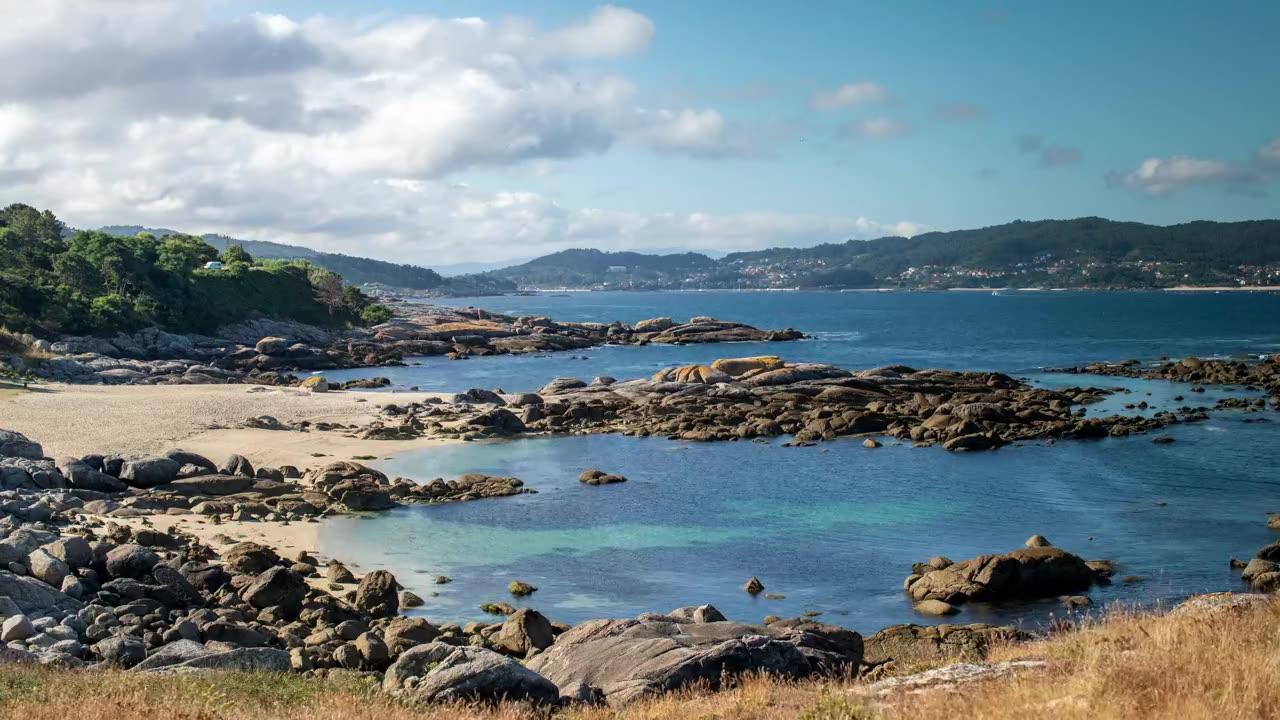 view of a beautiful beach full of rocks - One News Page VIDEO