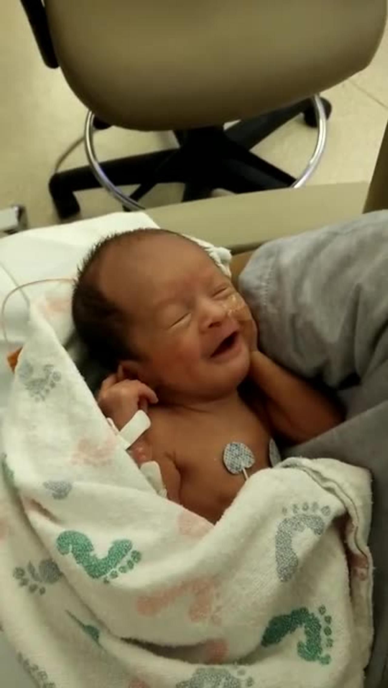 Preemie Baby Smiling and Giggling being held by - One News Page VIDEO